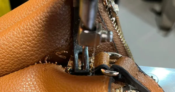Leather bag repair Singapore using leather sewing machine.